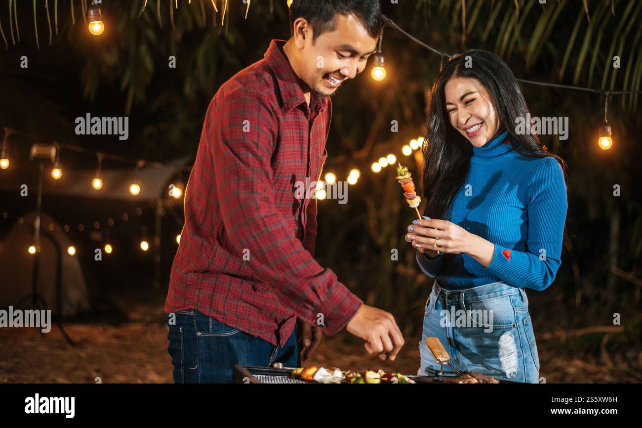 Happy Asian couple cheering with barbecue dinner outdoor - Group of ...