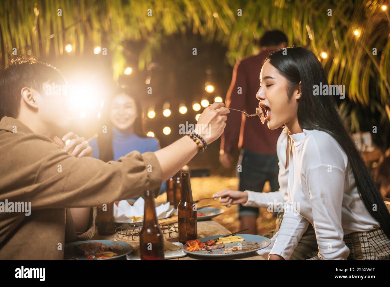 Happy Asian friends cheering with roasted turkey dinner outdoor - Group ...