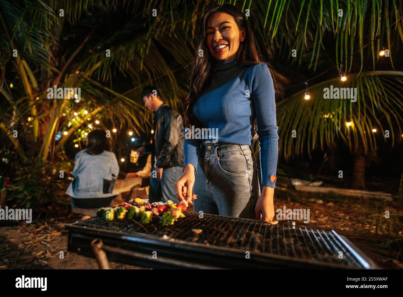 Young asian woman eating barbeque hi-res stock photography and images - Alamy