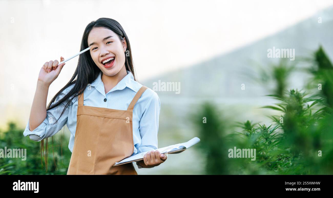 Portrait of Asian woman marijuana researcher thinking in cannabis farm ...