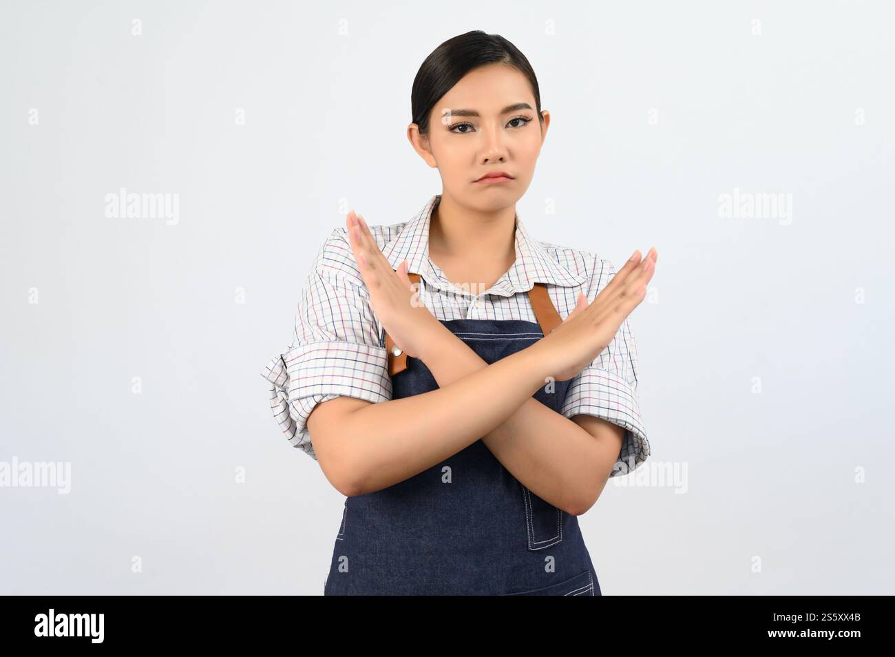 Portrait Asian young woman in waitress uniform and apron standing ...