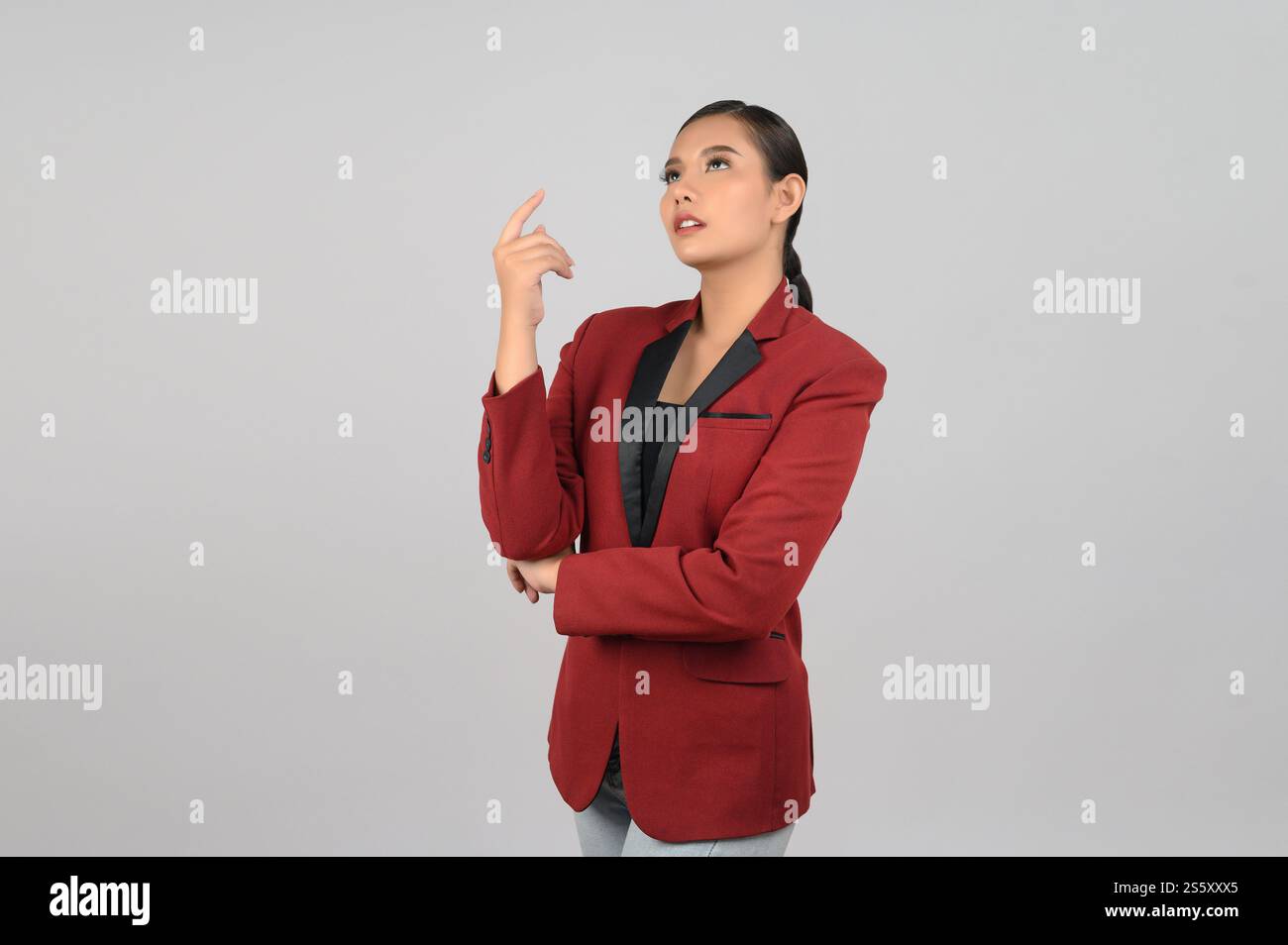 Portrait Asian young woman in officer uniform standing and thinking ...
