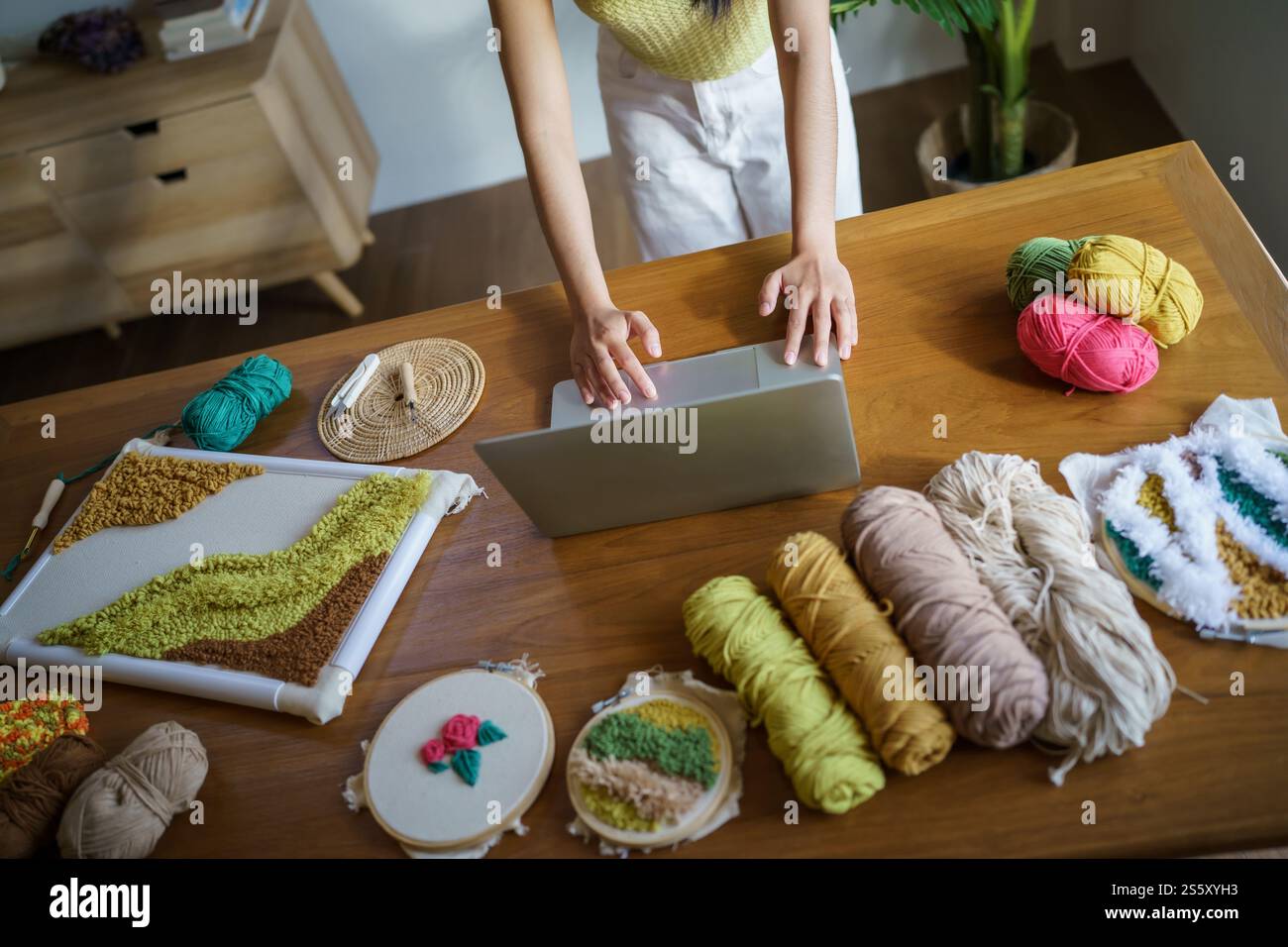 Small business. smiling young entrepreneur Asian Woman. Punch needle ...