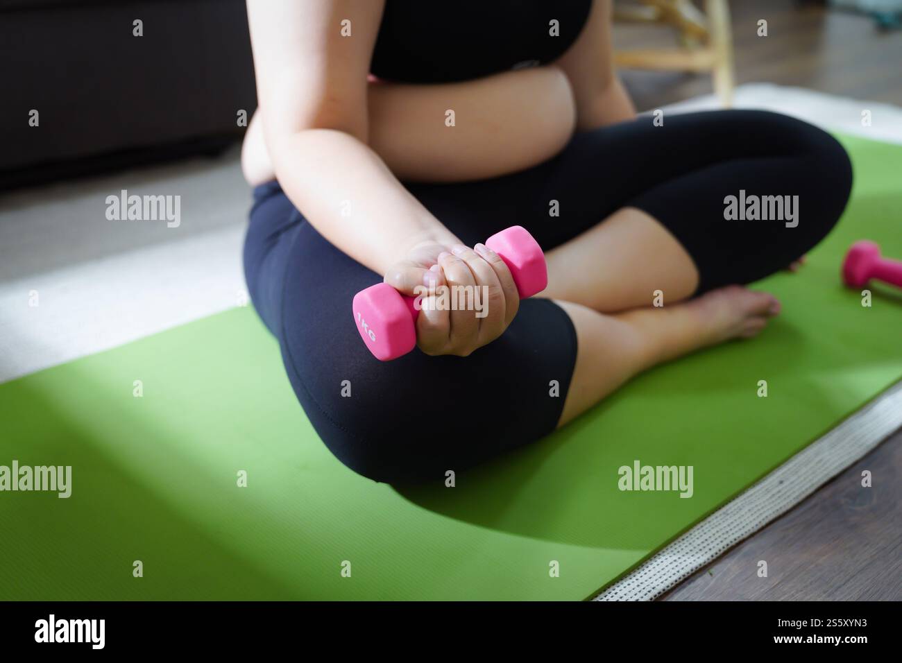 Overweight woman exercising for weight loss. exercise with dumbbells in ...