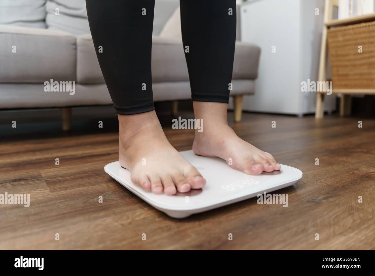 Fat diet and scale feet standing on electronic scales for weight ...
