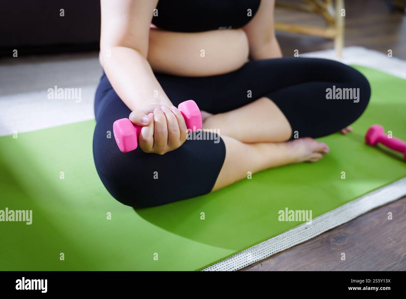 Overweight woman exercising for weight loss. exercise with dumbbells in ...