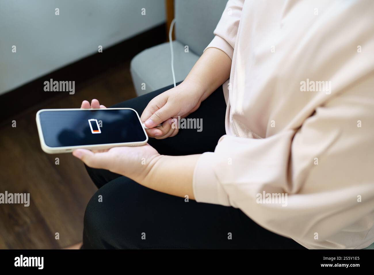 Woman hands Charging mobile phone battery with low battery. plugging a ...
