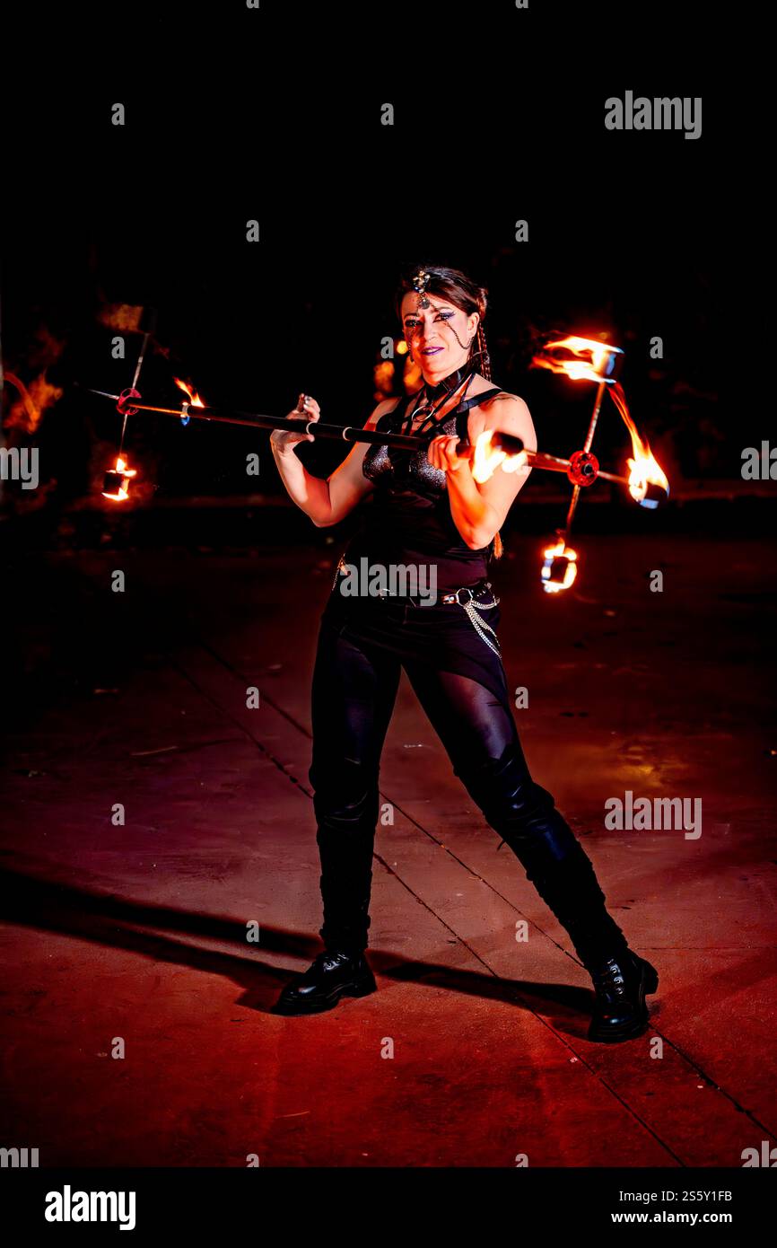 Fire artist captivating the audience while performing with a flaming ...