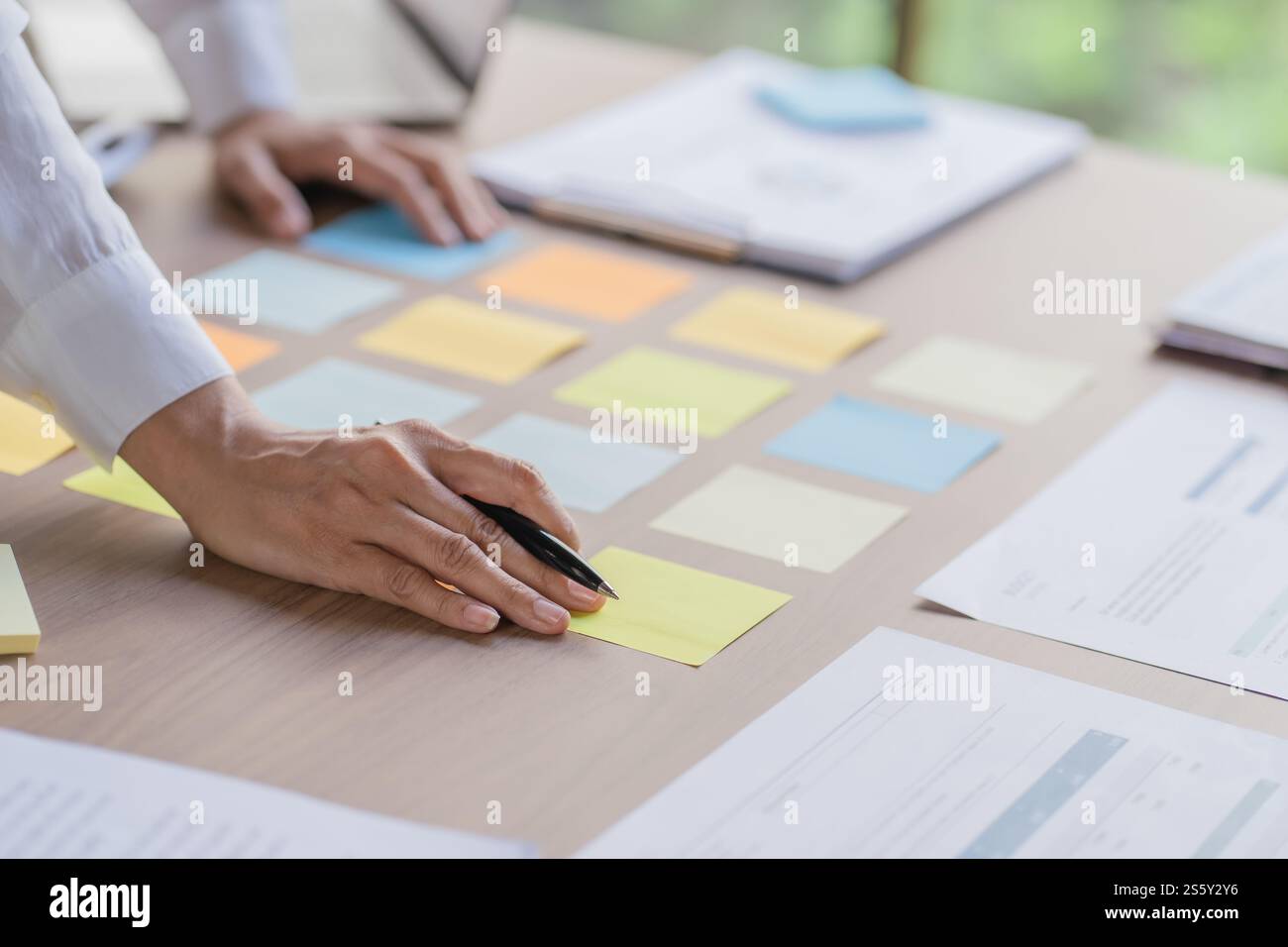 Business People working on sticky notes creative writing down ideas on ...