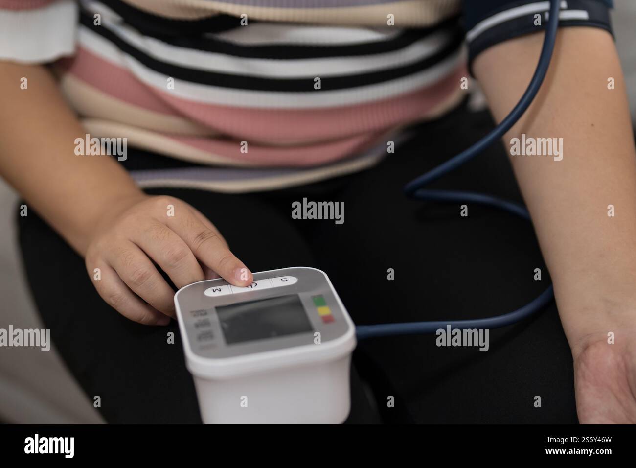 woman Overweight plus size self checks measuring blood pressure and ...
