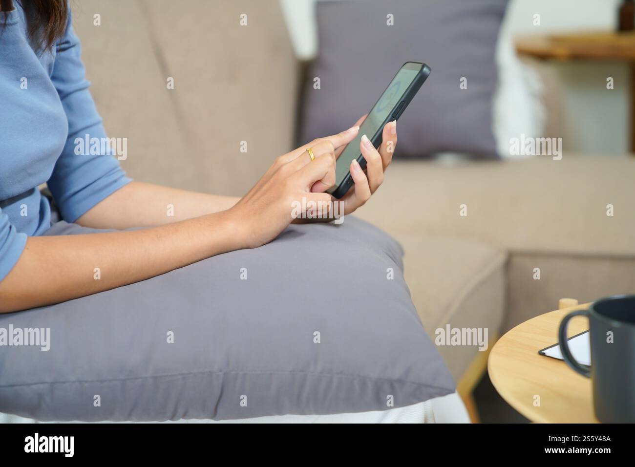 Asian Woman controlling smart home. mobile phone with smart home app in ...