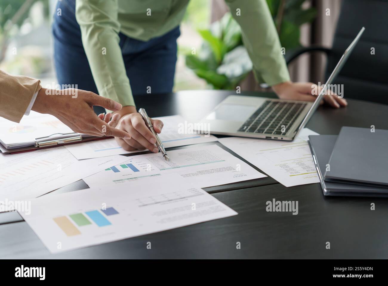 Team leader coach teach young workers explain on paper for business ...