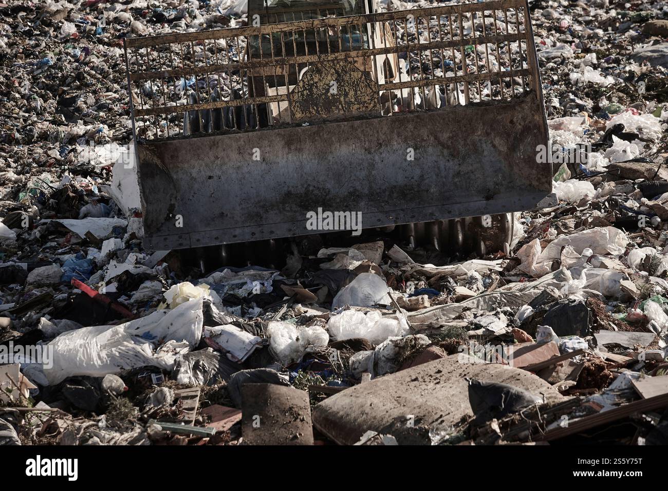 Heavy machinery shredding garbage in an open air landfill. Waste Stock ...