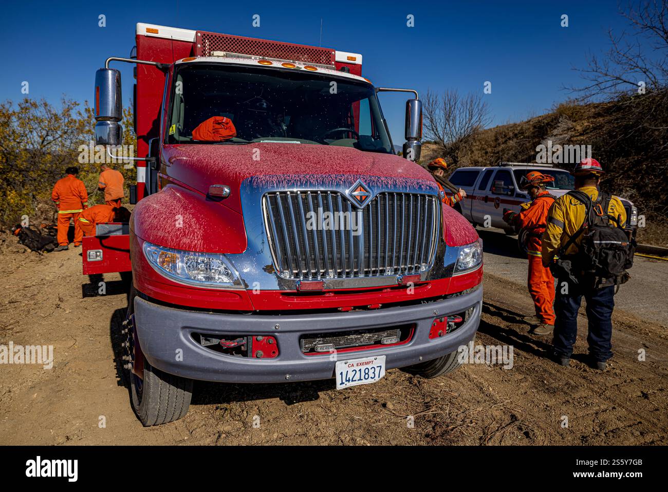 Inmates from California’s prisoner firefighter program coil hose along ...