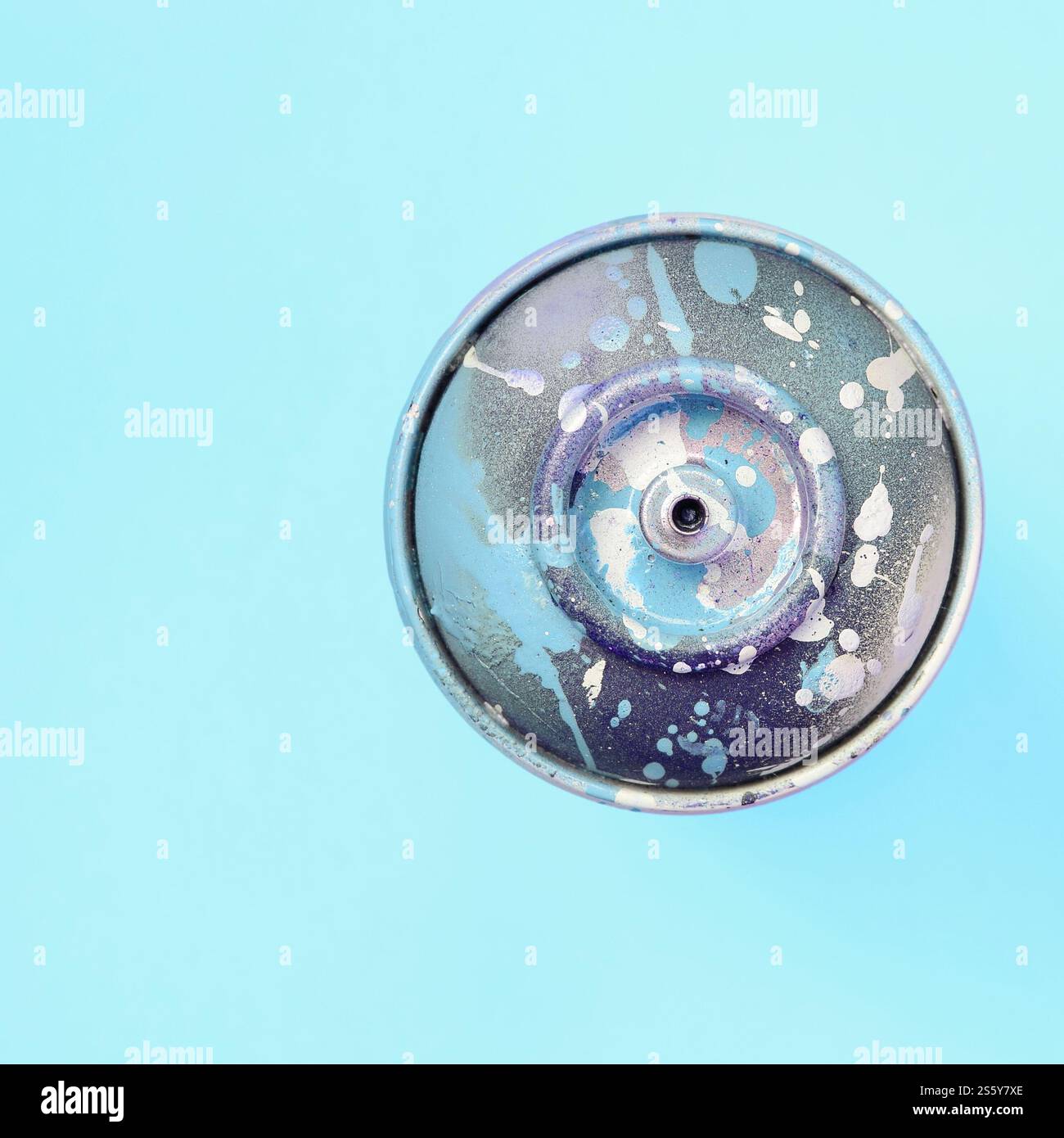 Used spray can with blue paint drips lie on texture background of ...