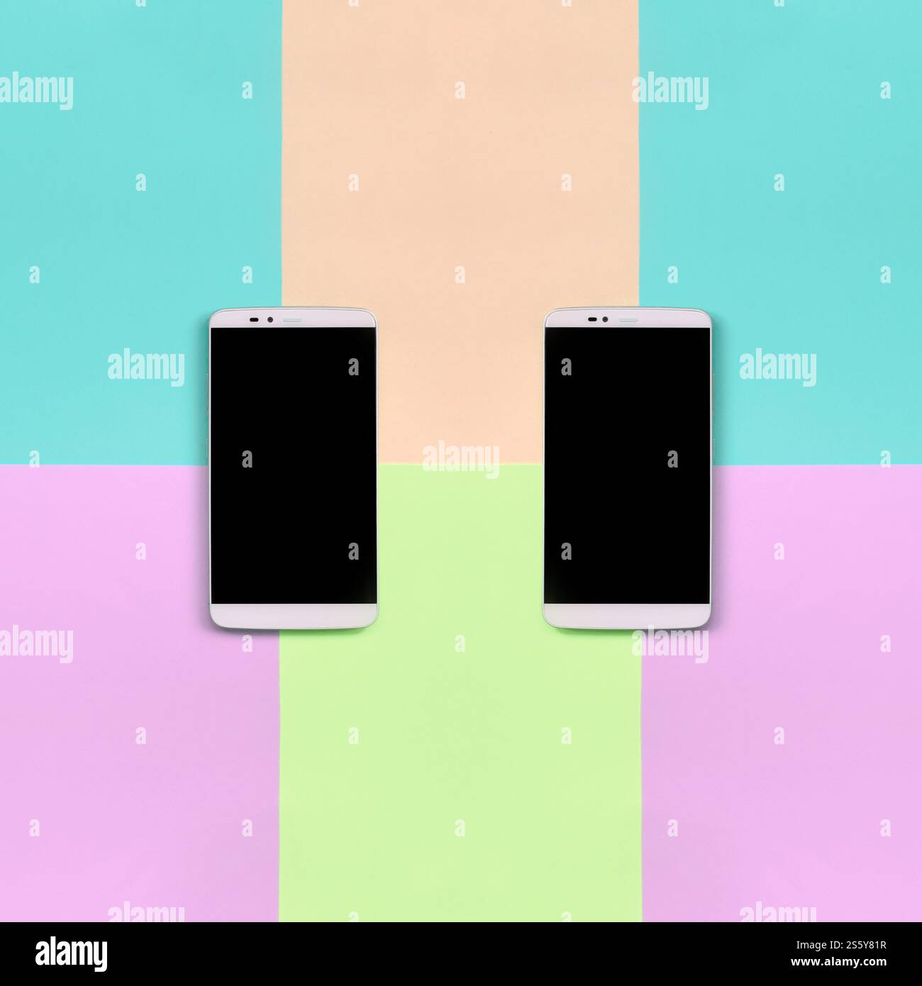 Two modern smartphones with black screens on texture background of ...