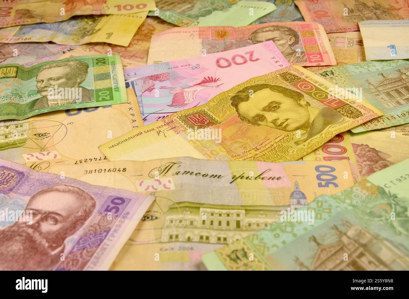 Background image of many Ukrainian banknotes of different colors and ...