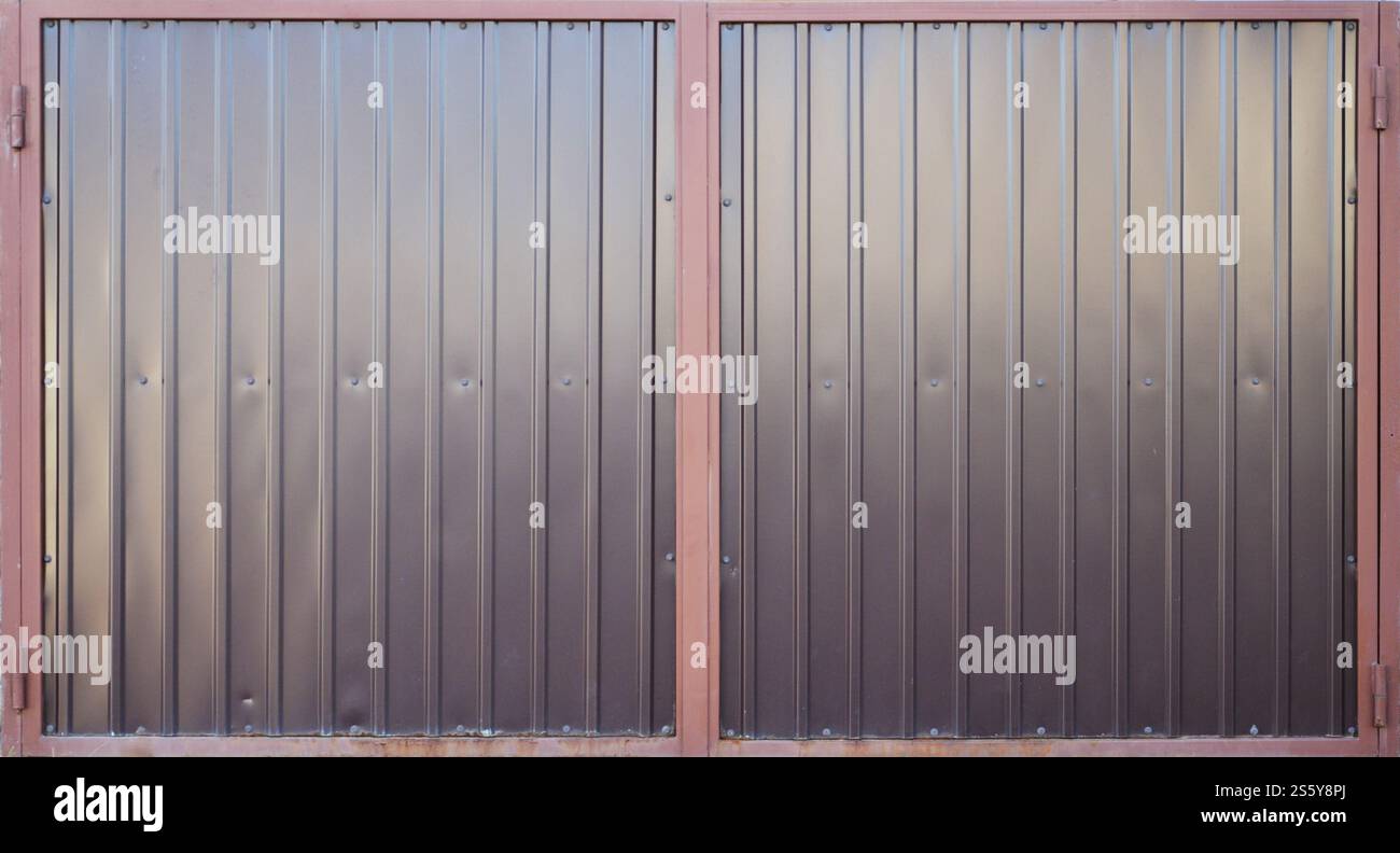 The texture of brown corrugated metal door with a colored frame. The ...