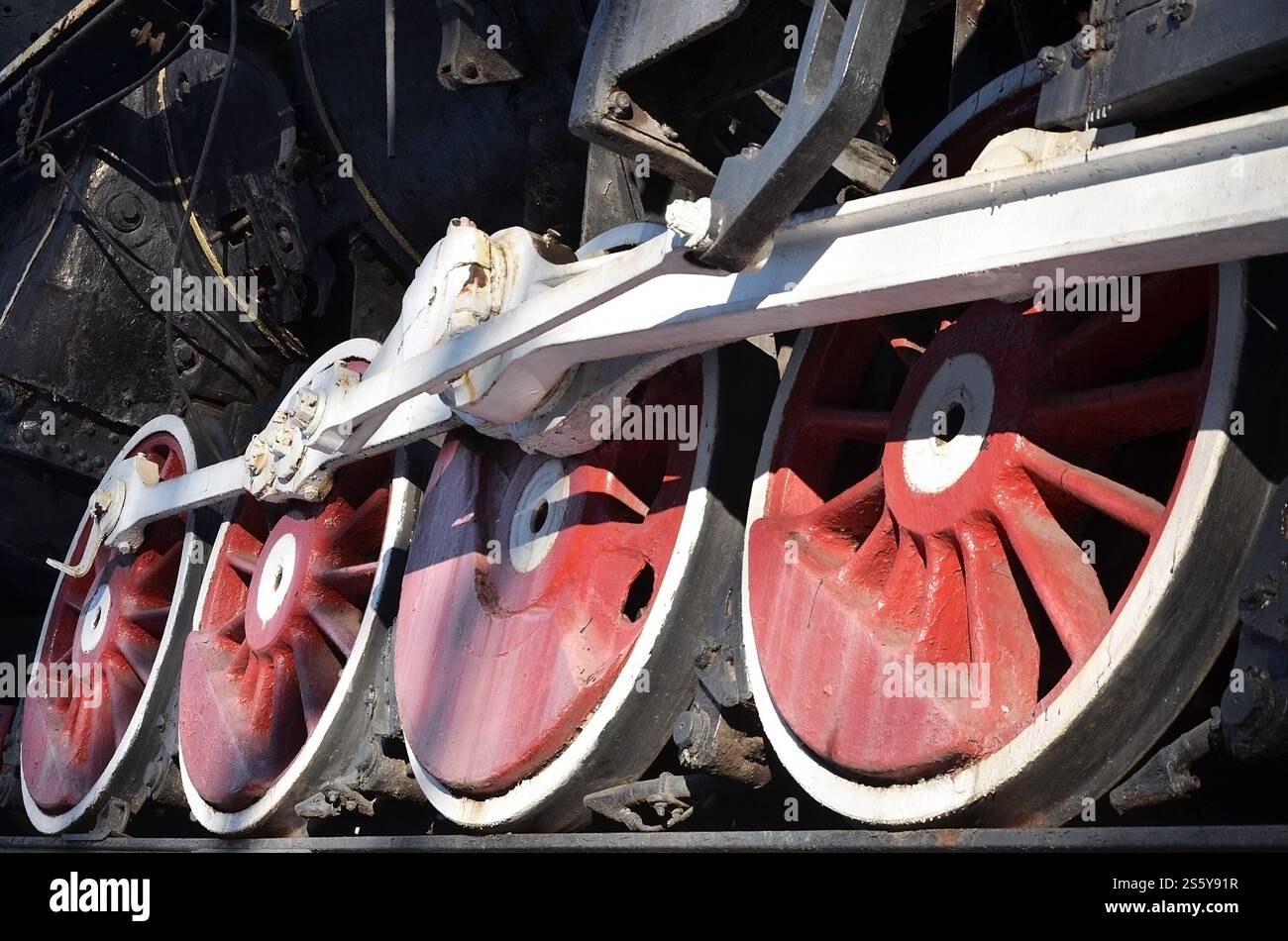 Red wheels of old USSR black steam locomotive. Wheels of an old soviet ...