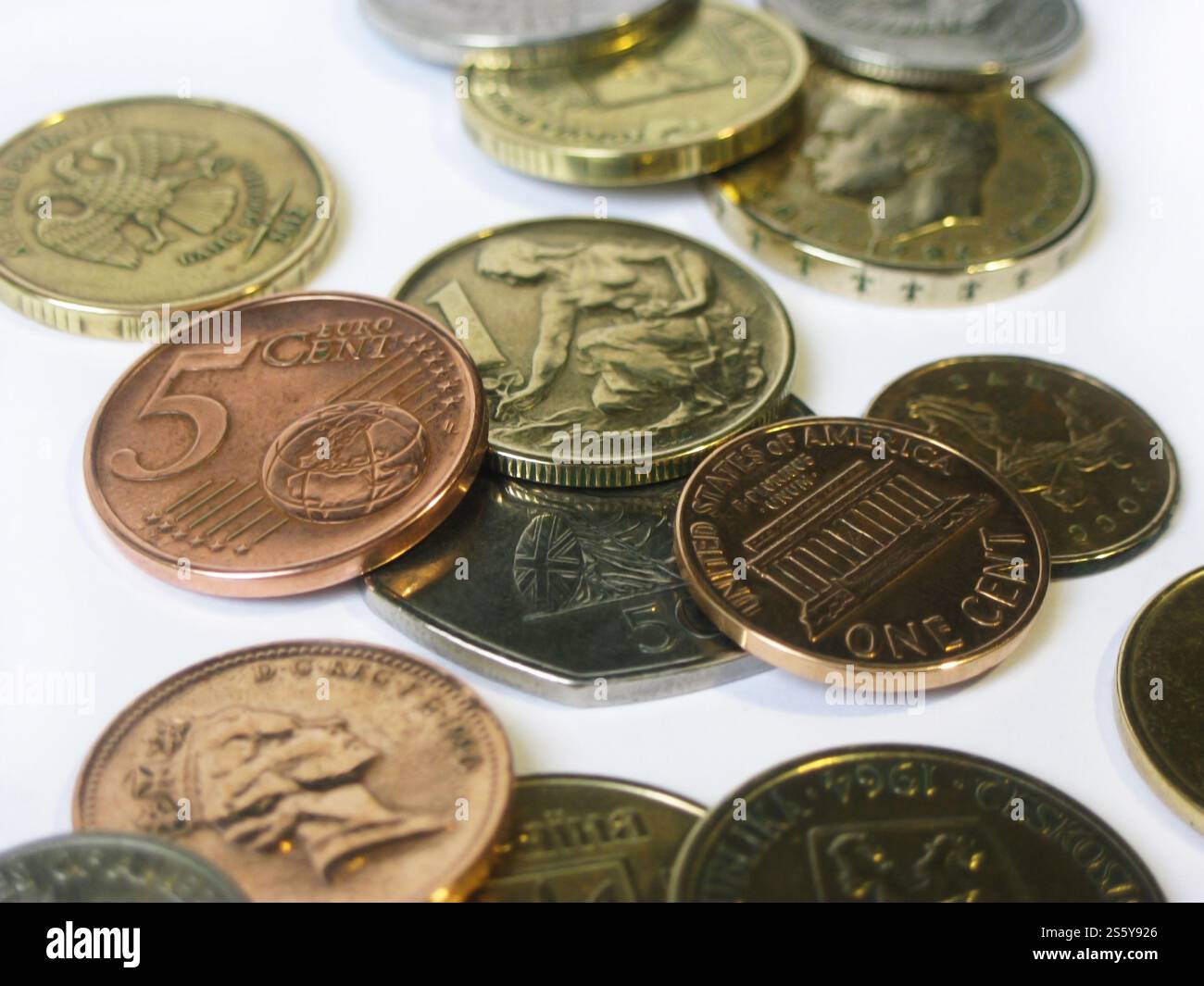 Different coins from various countries in macro on a white background ...