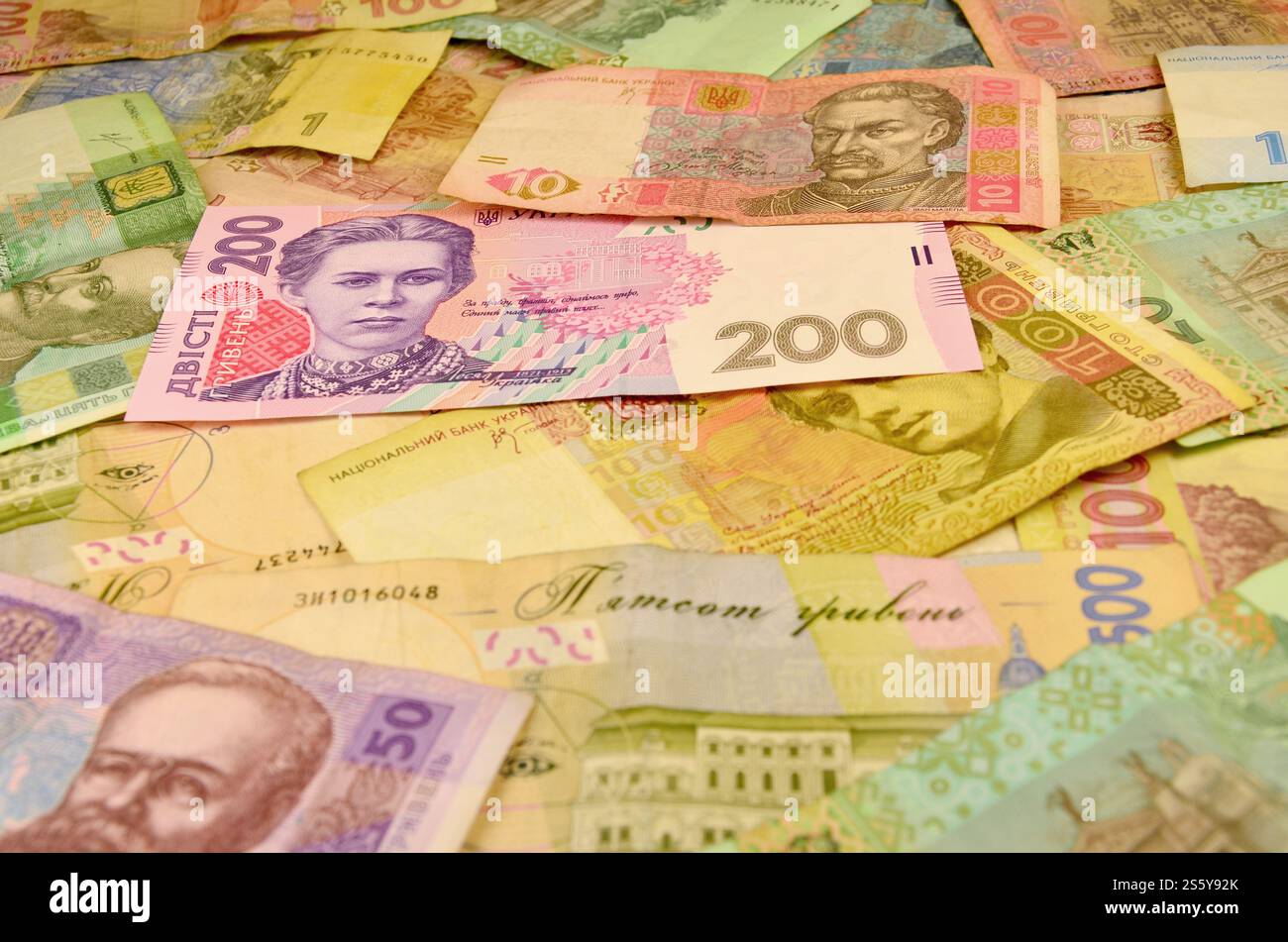Many Ukrainian money bills of various denominations and colors ...