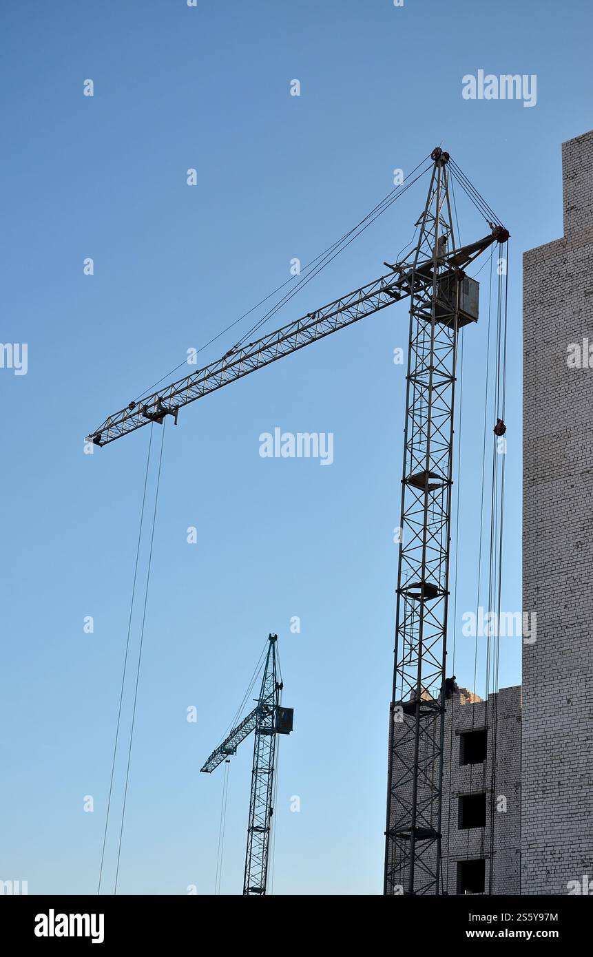 Working tall cranes inside place for with tall buildings under ...