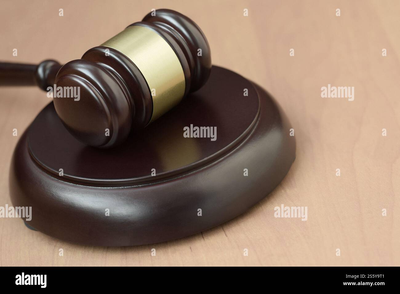 Justice mallet on wooden desk in a courtroom during a judicial trial. Law concept and empty copy ...