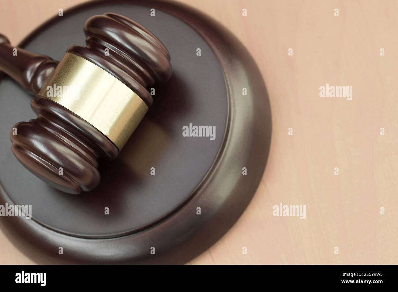 Justice mallet on wooden desk in a courtroom during a judicial trial. Law concept and empty copy ...