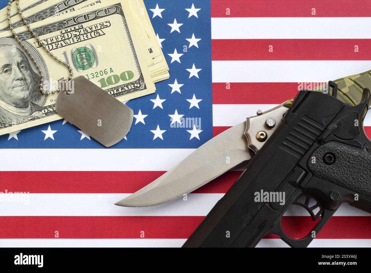 Close up dollar money with weapons and military badges on United States ...