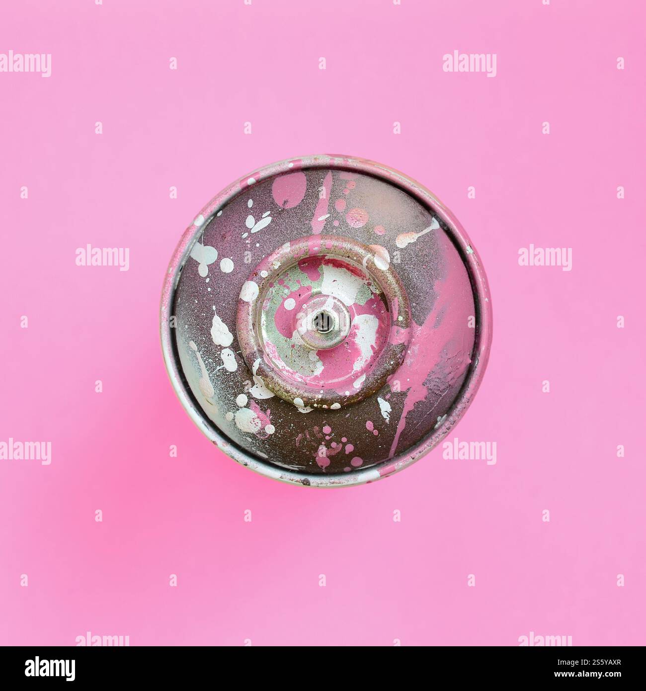 Used spray can with pink paint drips lie on texture background of ...