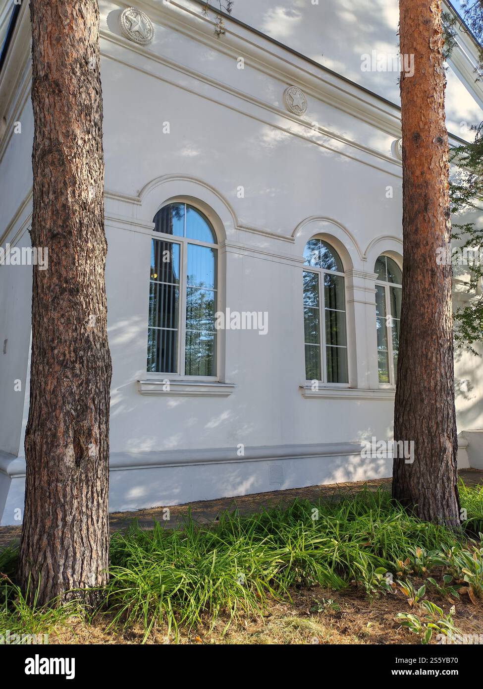 A close-up of a neoclassical building facade with arched windows and ...