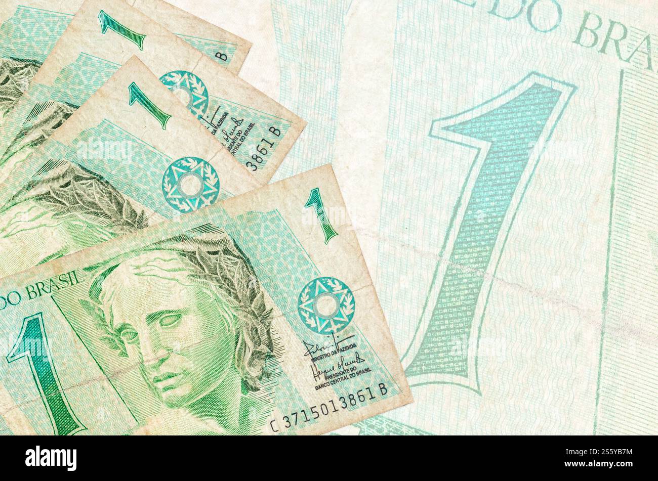 1 Brazilian real bills lies in stack on background of big semi ...