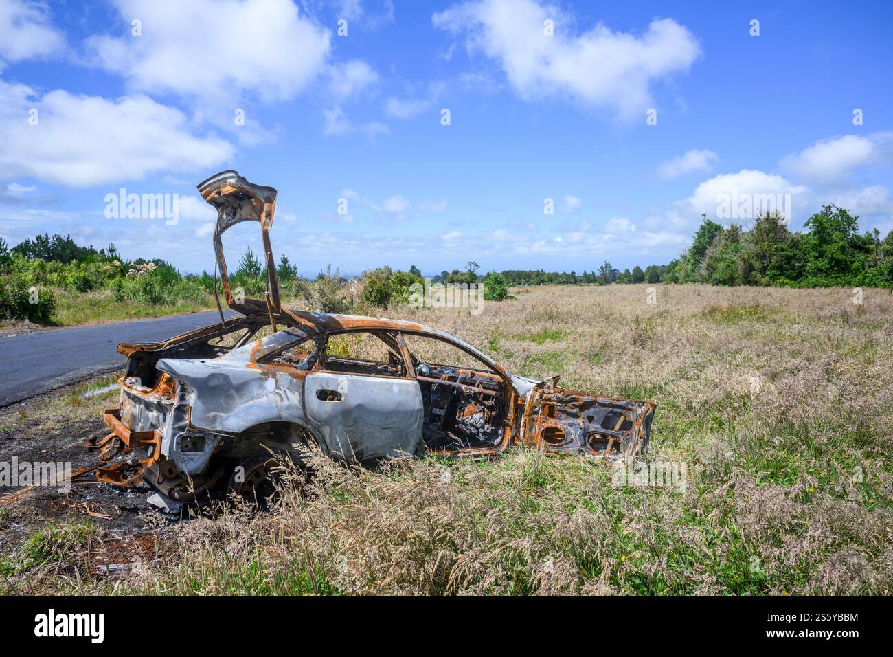 Burnt out car dumped by the side of the road Stock Photo - Alamy