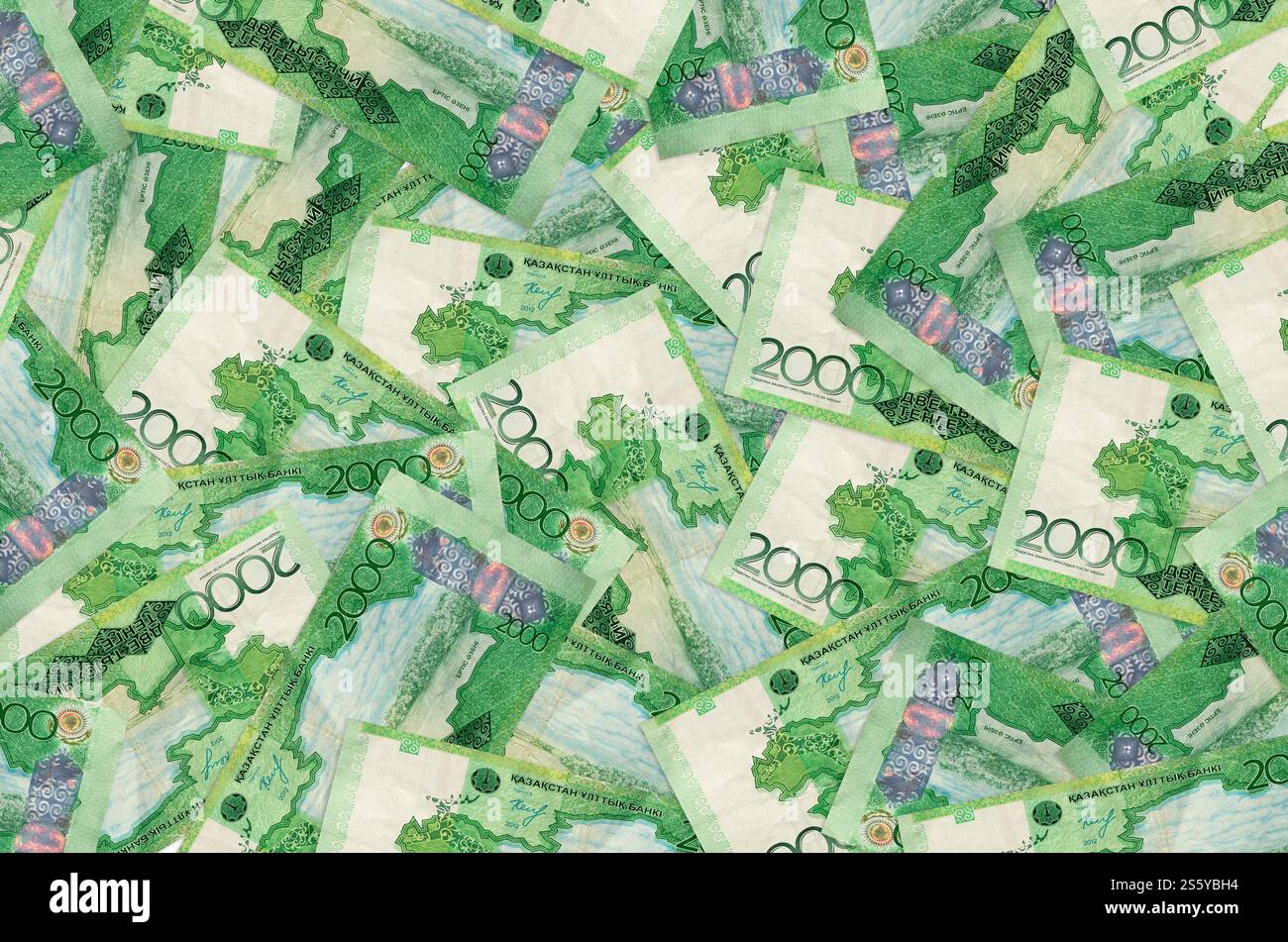 2000 Kazakhstani tenge bills lies in big pile. Rich life conceptual ...