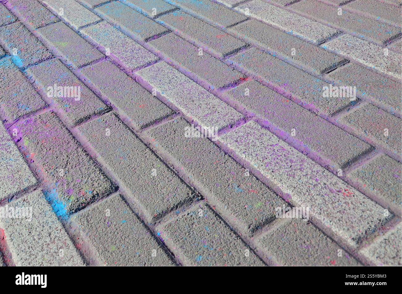 Multi colored earth, paving slabs, powder coated with dry colors at the Holi festival close up ...