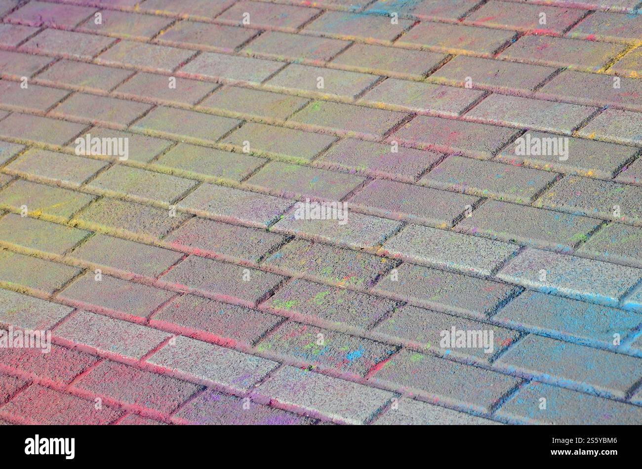 Multi colored earth, paving slabs, powder coated with dry colors at the Holi festival close up ...