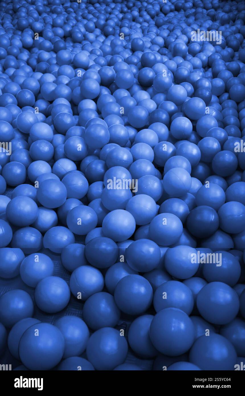 Many plastic balls in a kids ballpit at a playground. Close up pattern ...