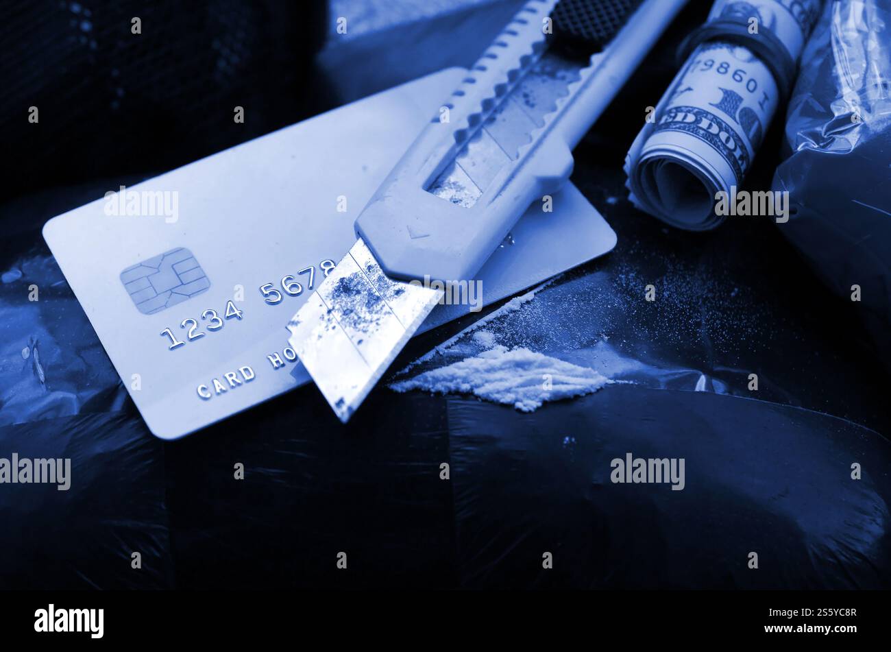 Spoon full of heroin and paper knife lies on drug packs and credit card ...