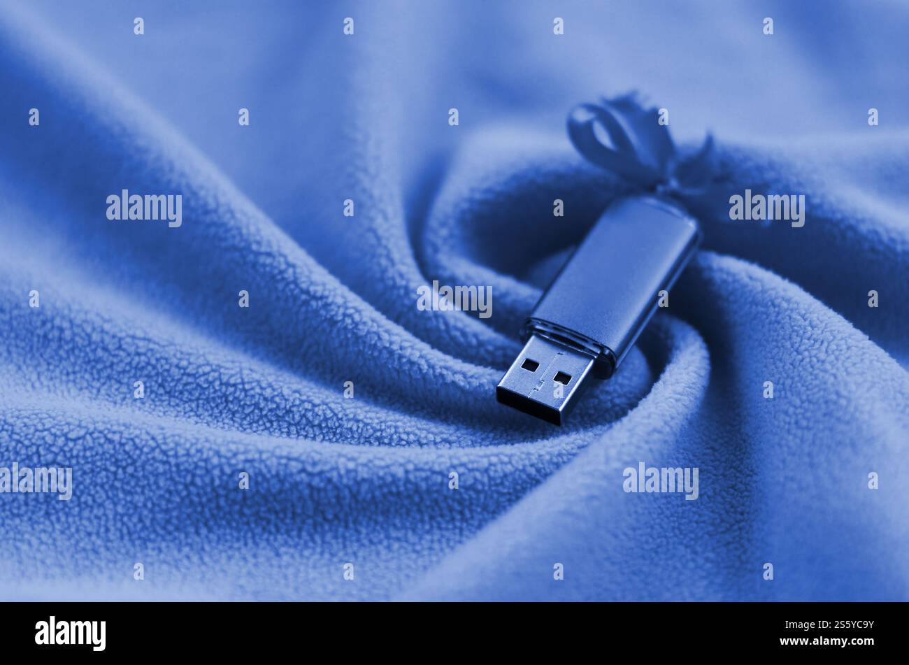 Usb flash memory card with bow lies on a blanket of soft and furry ...