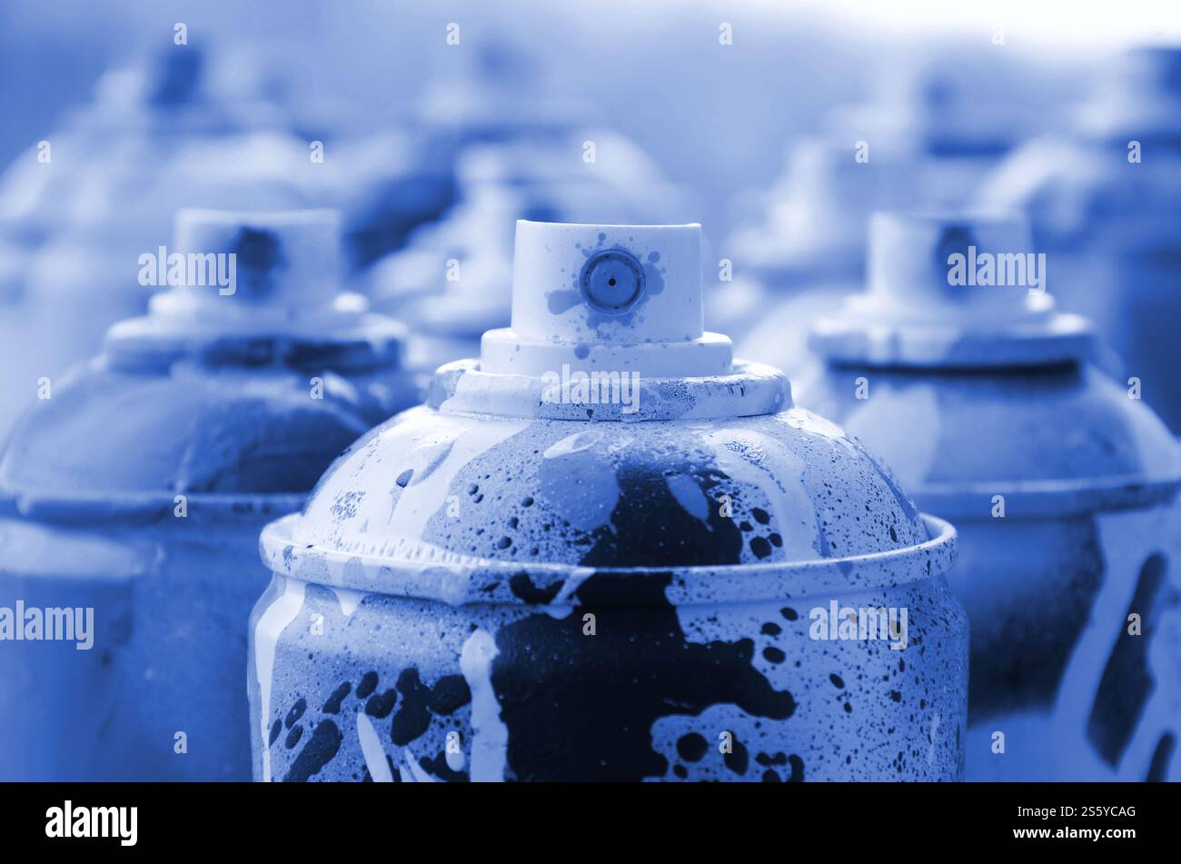 A lot of dirty and used aerosol cans of phantom classic blue color ...