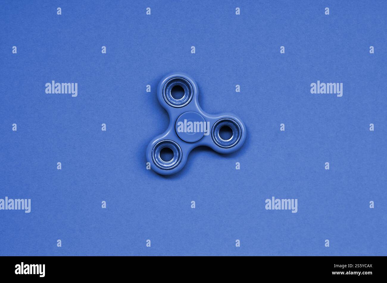Green fidget spinner lies on texture background of fashion pastel green ...