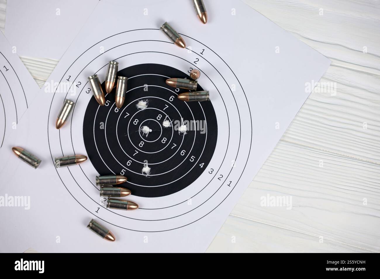 Many bullets with shooting targets on white table in shooting range ...