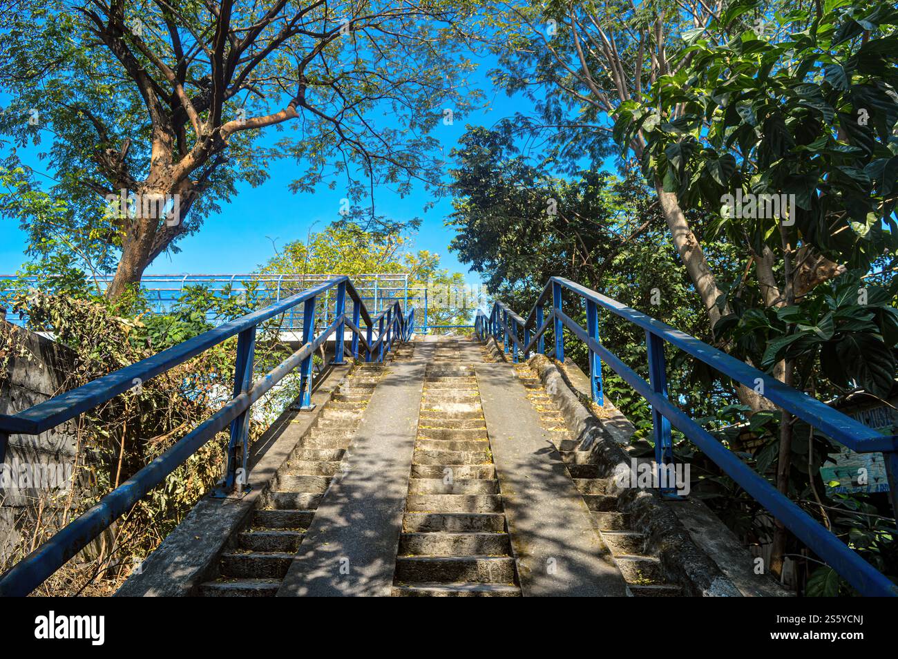 a concrete staircase part of a pedestrian bridge that crosses the ...