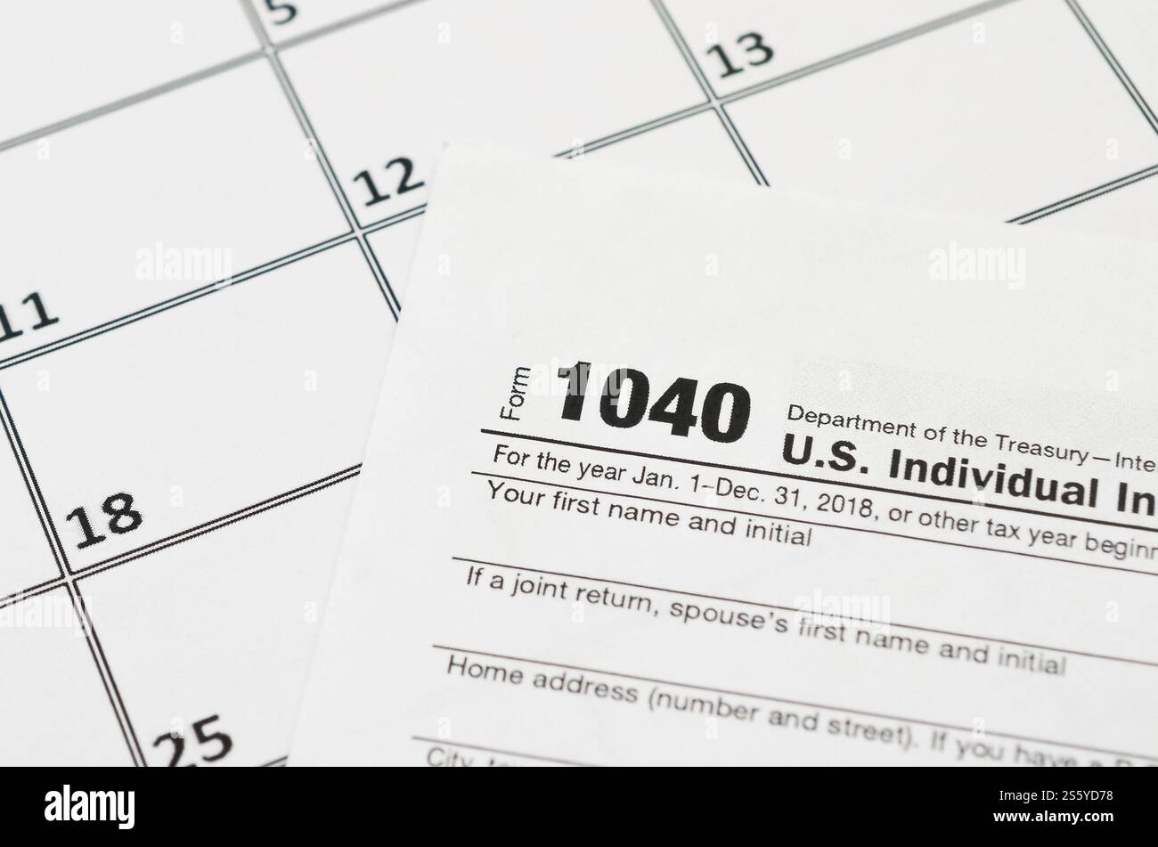 IRS Form 1040 Individual Income Tax Return blank lies on empty calendar ...