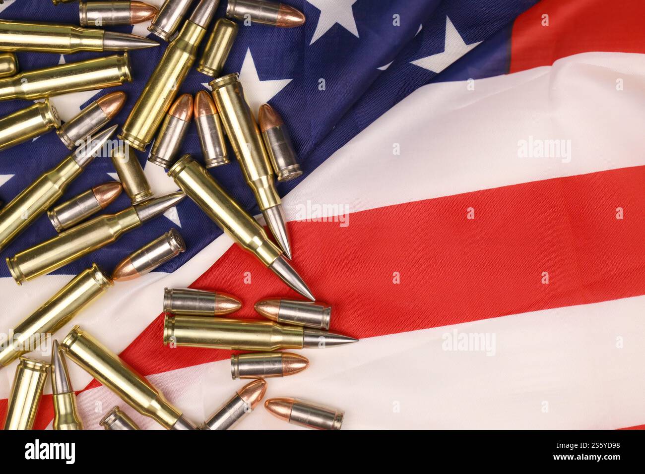 Many yellow 9mm and 5.56mm bullets and cartridges on United States flag ...