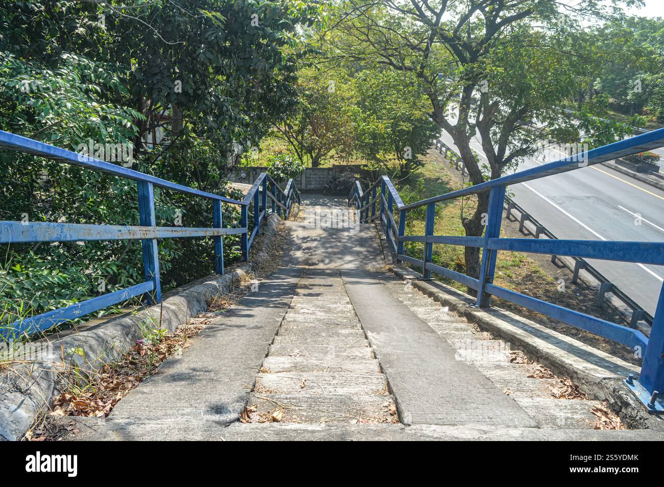 a concrete staircase part of a pedestrian bridge that crosses the ...