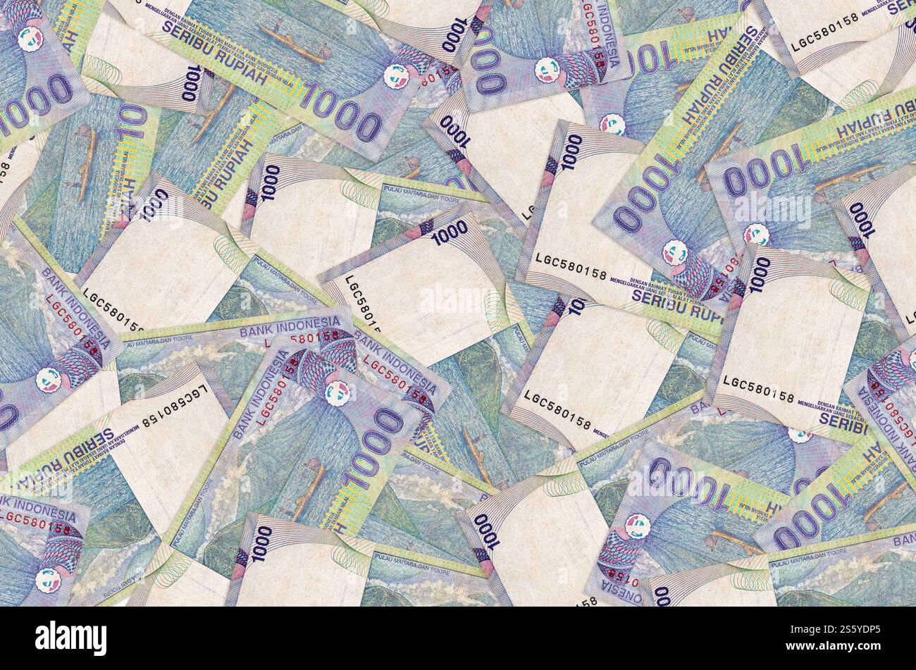 1000 Indonesian rupiah bills lies in big pile. Rich life conceptual ...