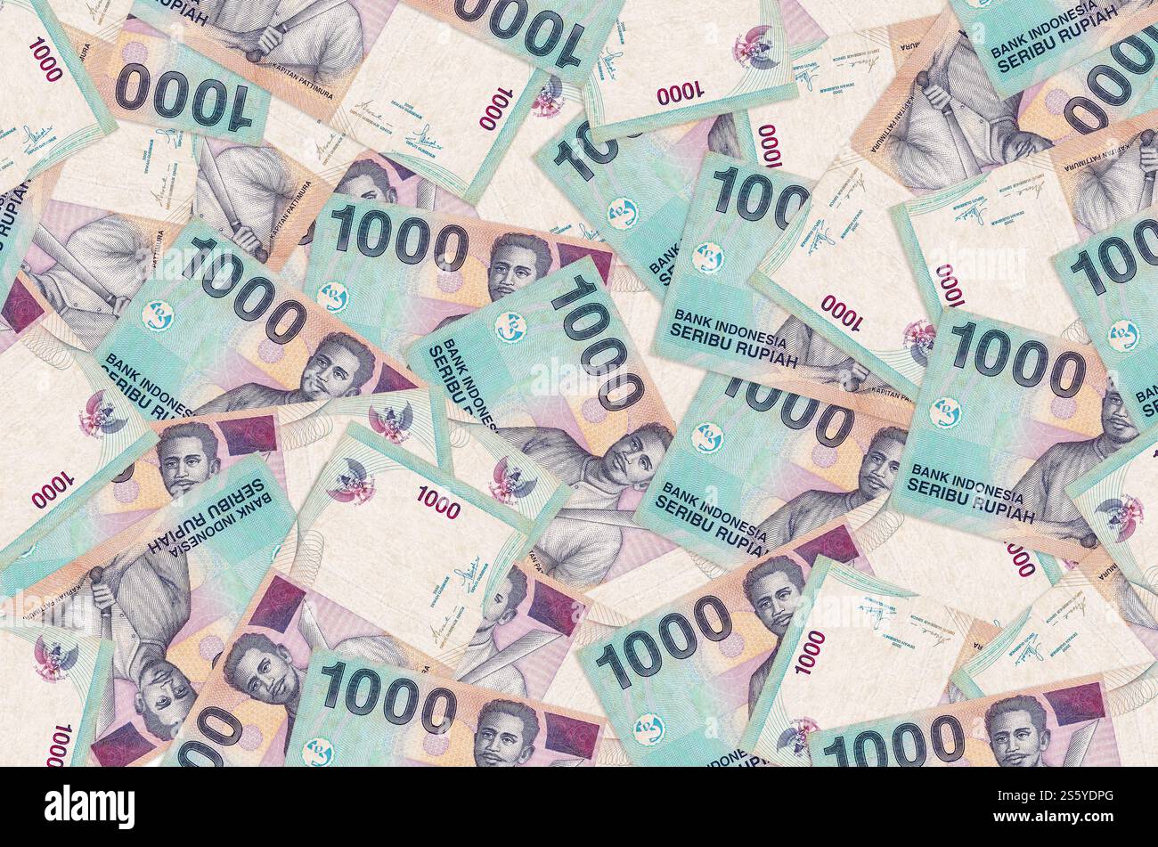 1000 Indonesian rupiah bills lies in big pile. Rich life conceptual ...
