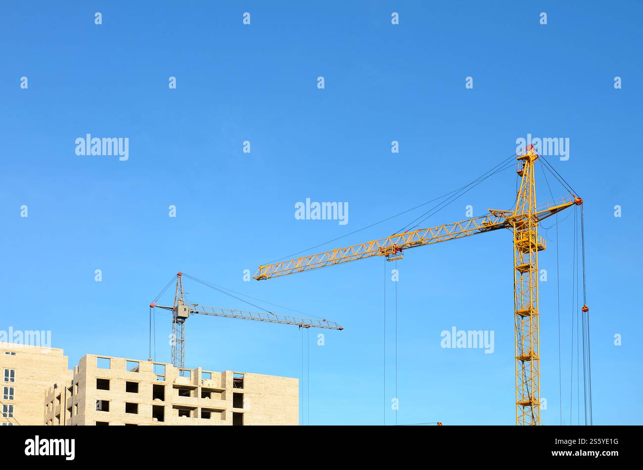 Working tall cranes inside place for with tall buildings under ...