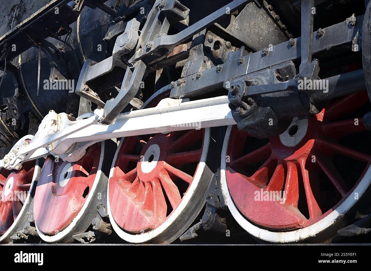 Red wheels of old USSR black steam locomotive. Wheels of an old soviet ...